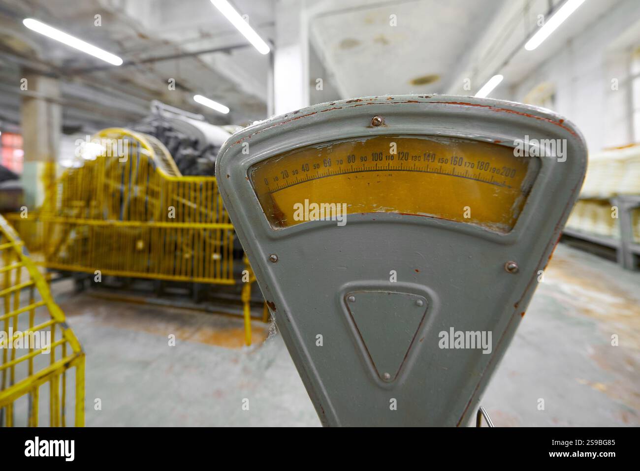 Vintage weighing scale in an industrial environment reflecting years of ...