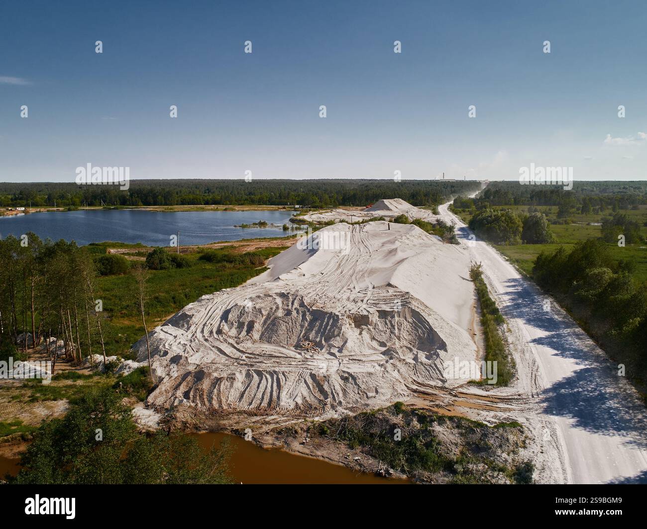 Huge mound of extracted river sand near pond in open quarry Stock Photo ...