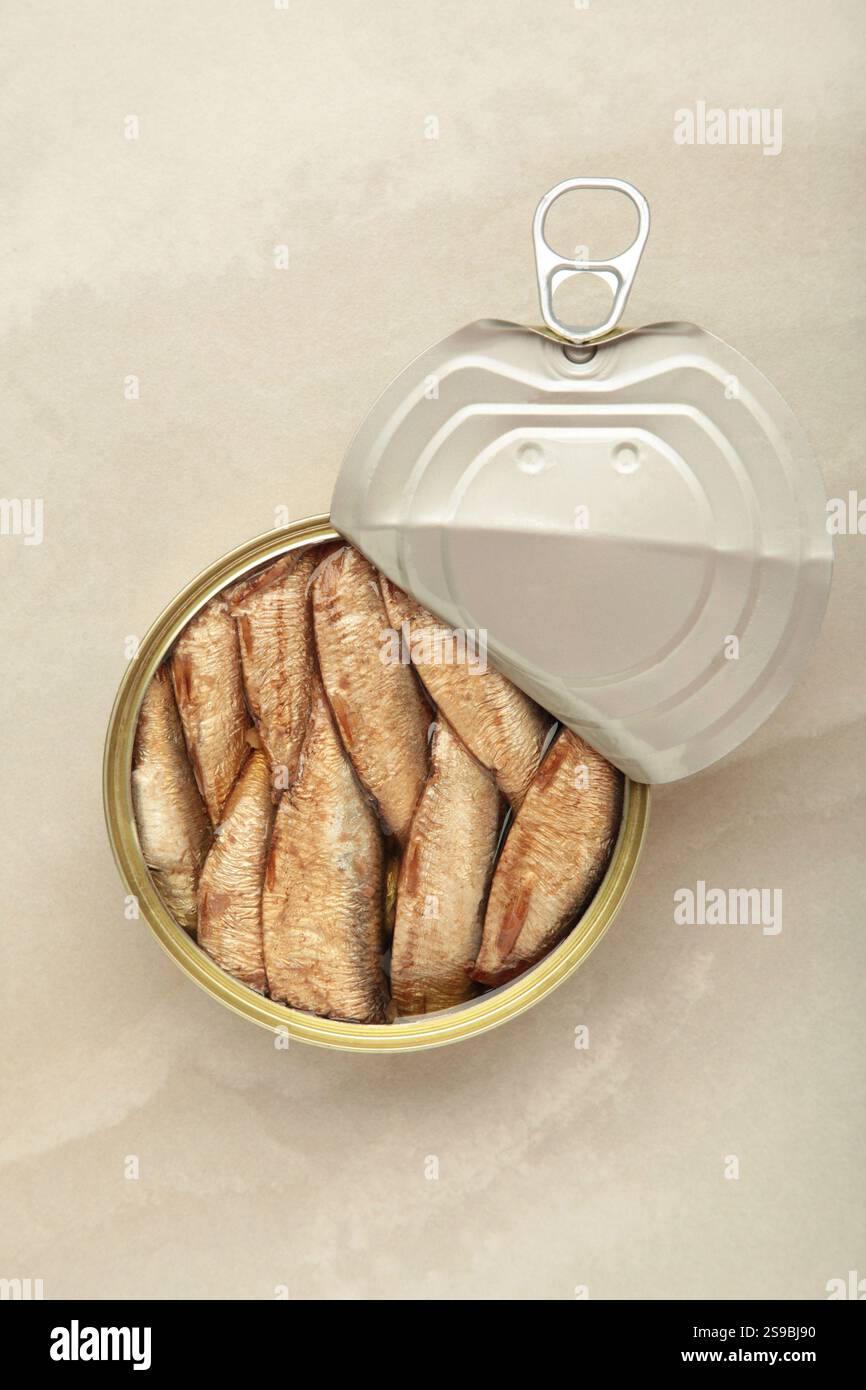 Canned smoked sprat fish in oil in jar on light background. Vertical ...