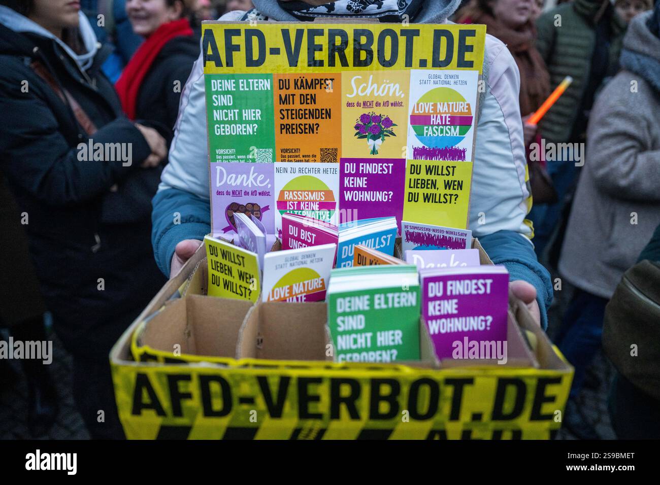 25 January 2025, Berlin: A participant distributes stickers from the ...