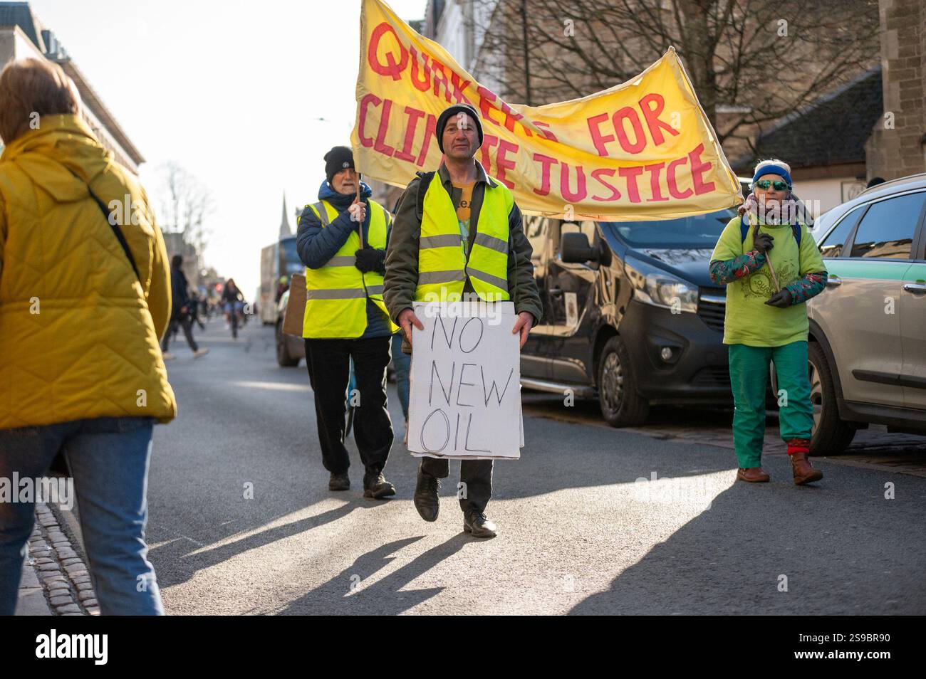 Demonstrators are seen marching with a banner and a placard during the ...