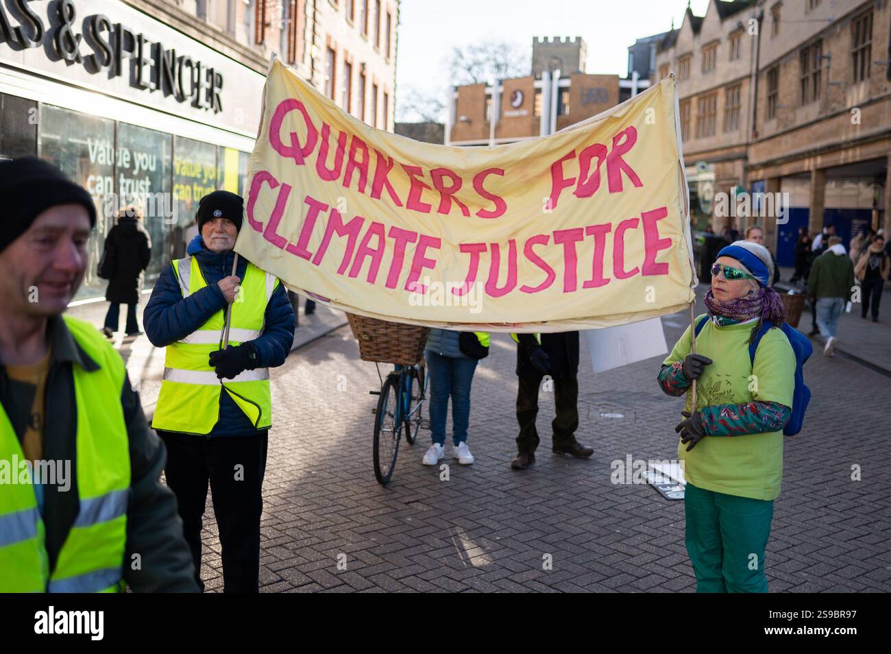 Demonstrators hold a banner during the protest. Quakers for Climate ...