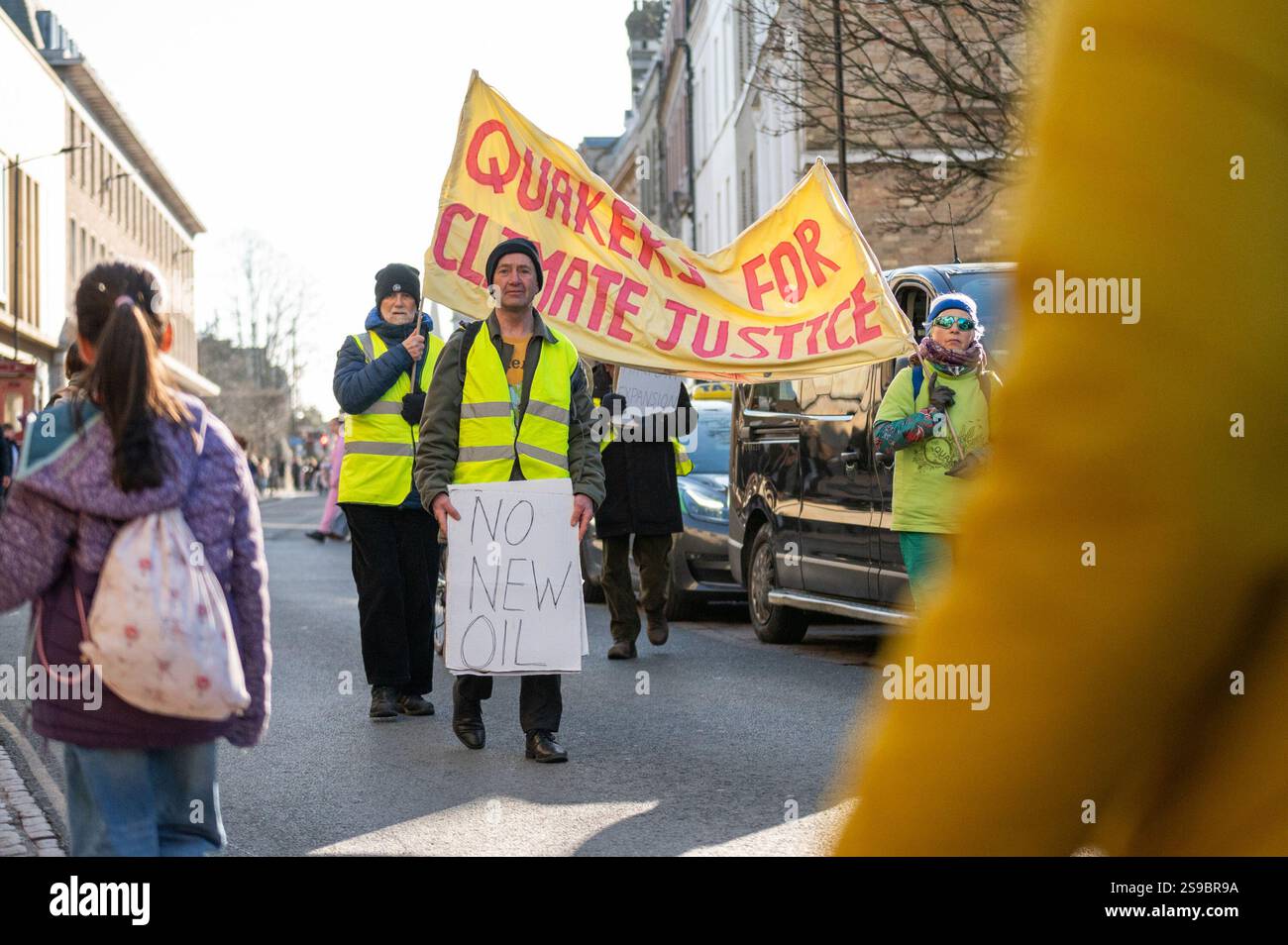 Demonstrators are seen marching with a banner and a placard during the ...