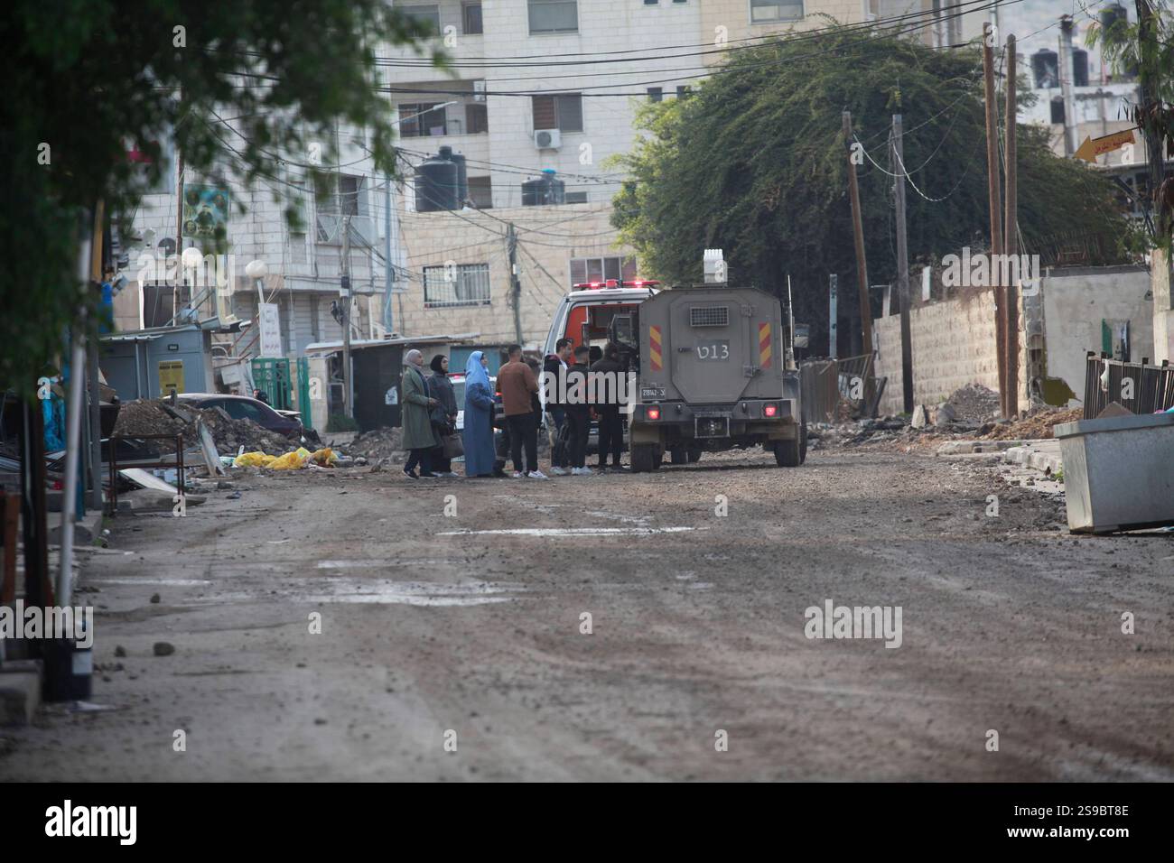 Palestinians inspect the destruction after an Israeli military ...
