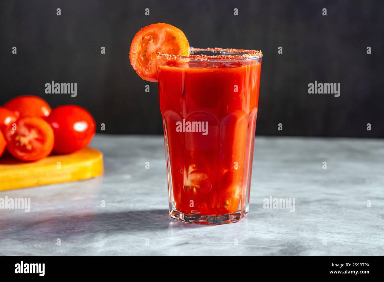 Refreshing vegetable cocktail. Tomato juice served in glass with tomato ...