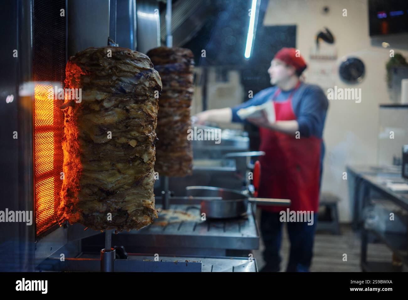 View of a street gyros shop, focus on the meat on the spit, and in the ...