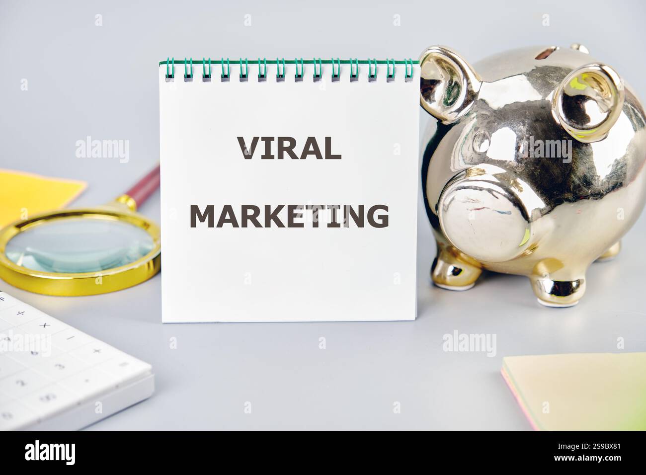 Notepad displays the term viral marketing alongside a golden piggy bank ...
