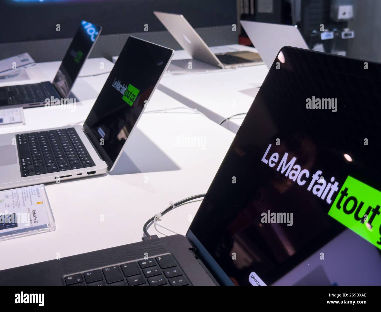 Modern laptops displayed prominently in a sleek tech showroom ...