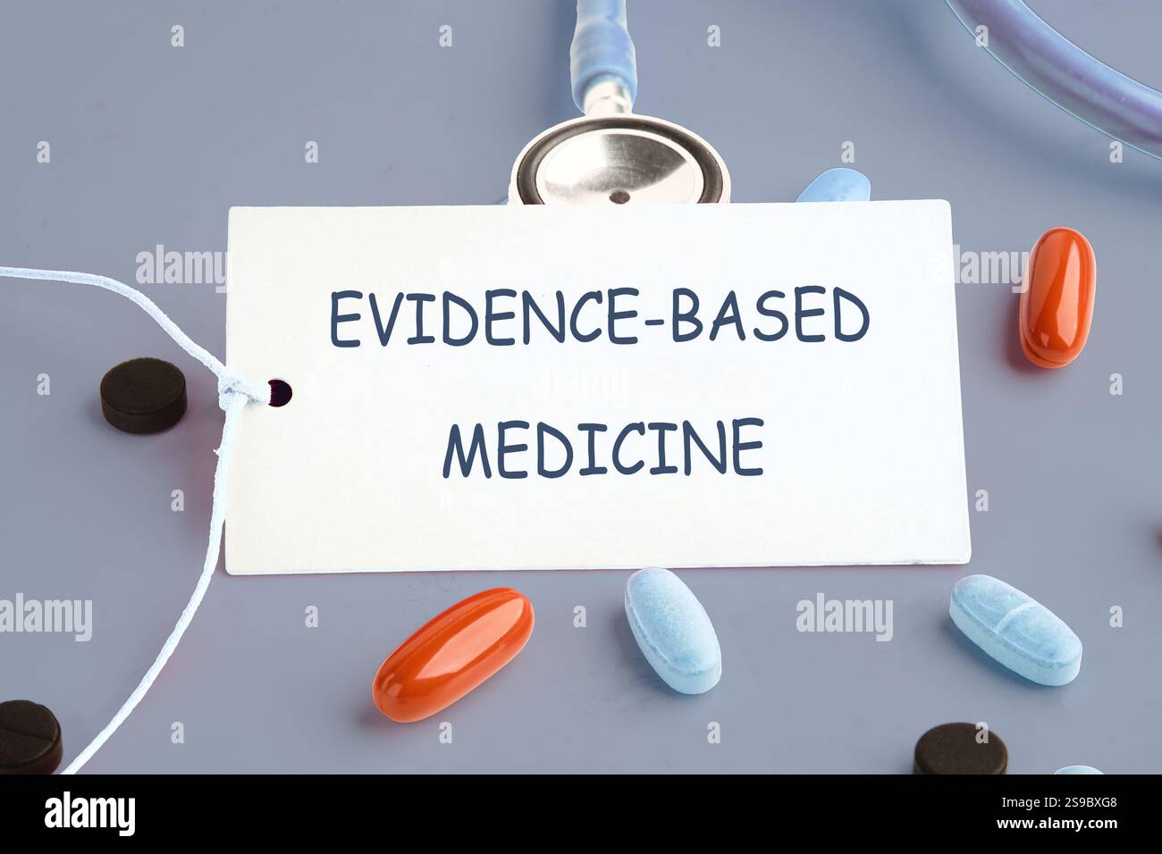 Evidence-based medicine is depicted with a tag and pills around medical ...