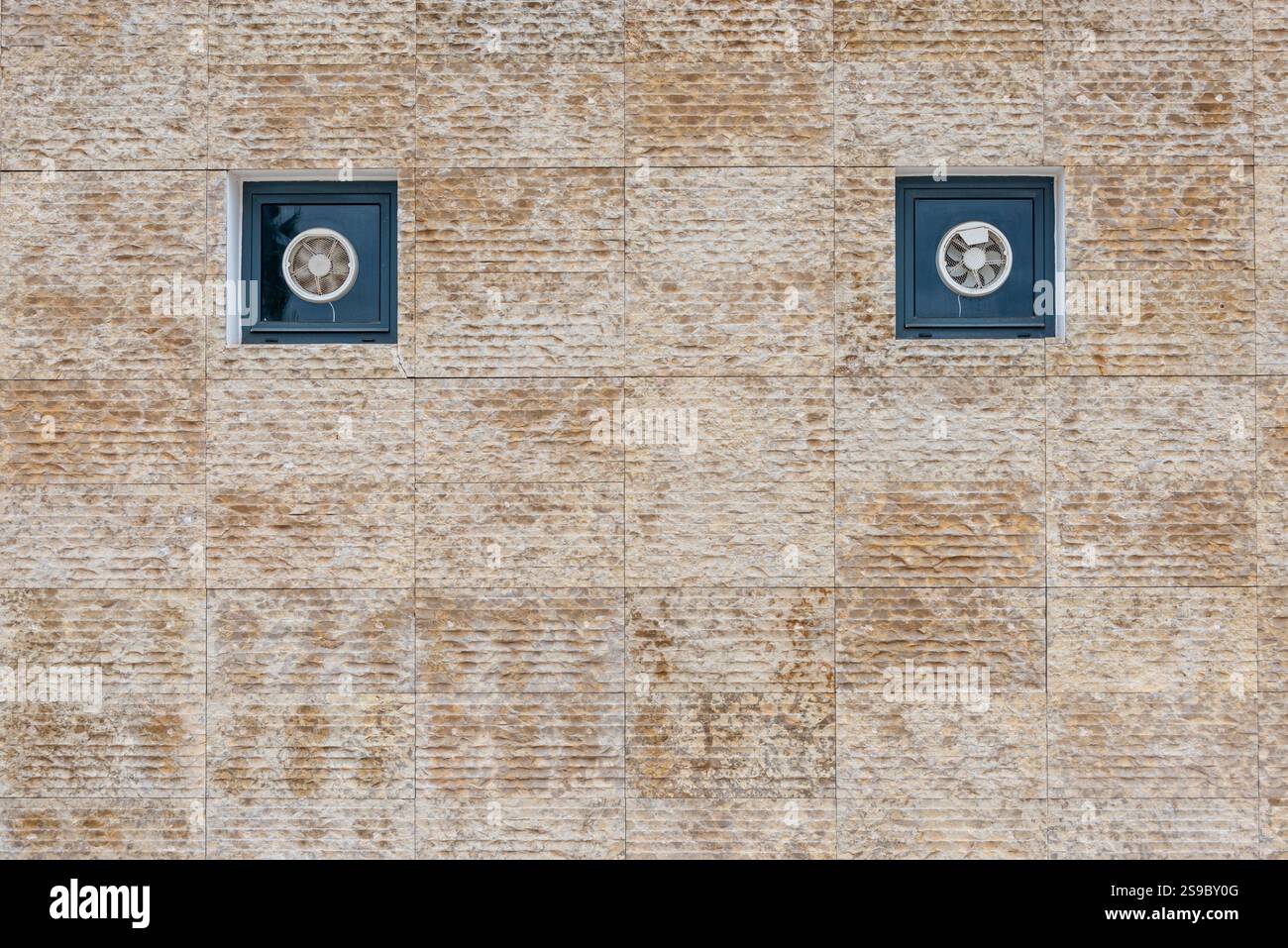 tiled exterior wall with small windows and air vents Stock Photo - Alamy