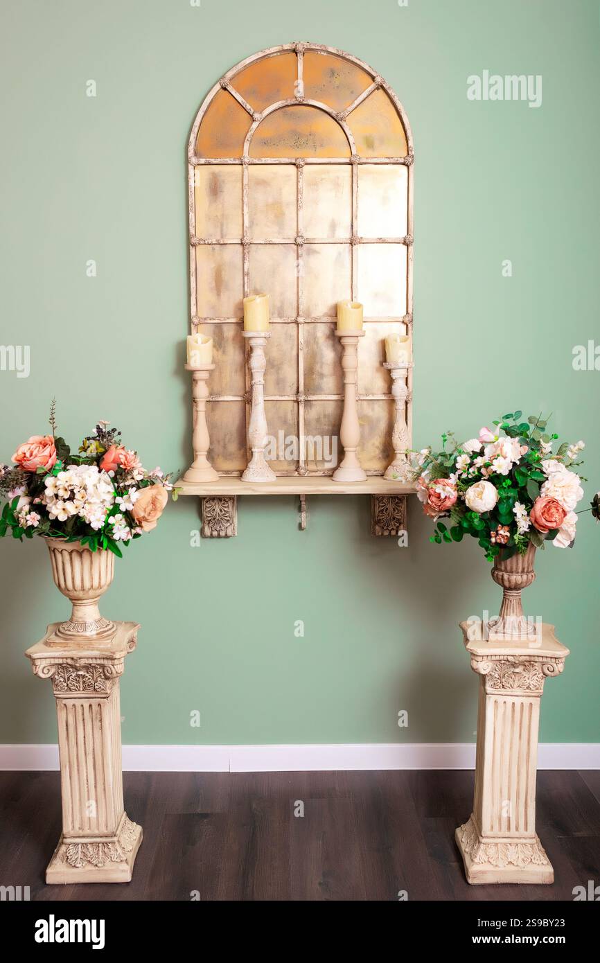 iron frame with mirror and two columns with flowers. classic photo zone ...