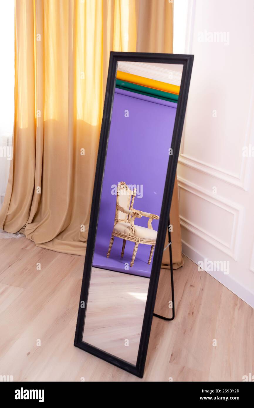 reflection of wooden chair on colored background in mirror. photo zone ...