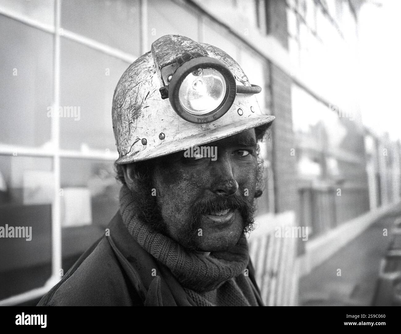 Young coal miner with his face covered in coal dust after working a ...