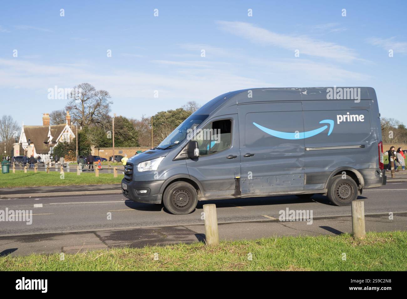 side view of amazon Prime delivery truck in grey out on the road in ...