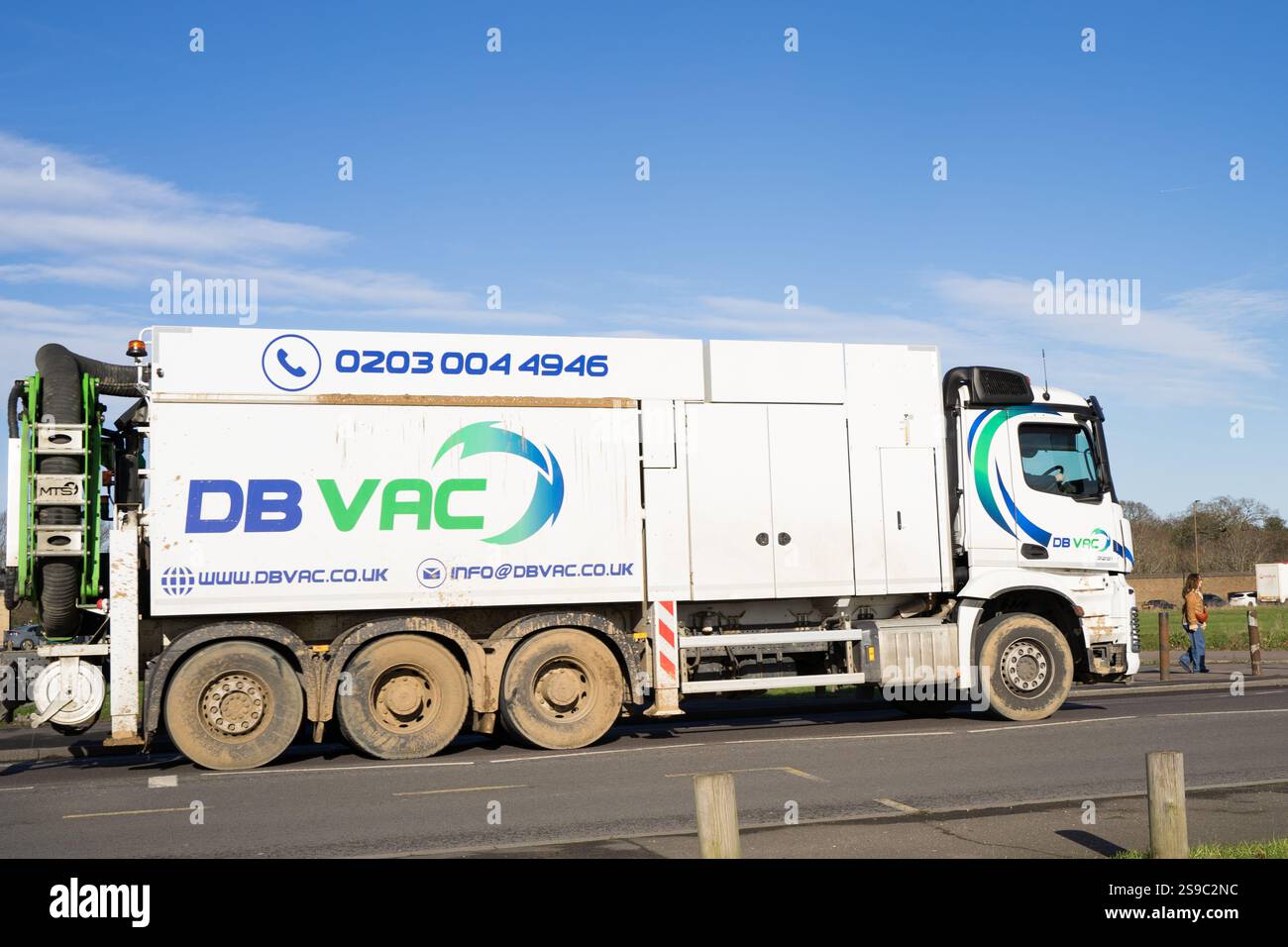 side view of DB VAC waste management vehicle truck out on the road ...