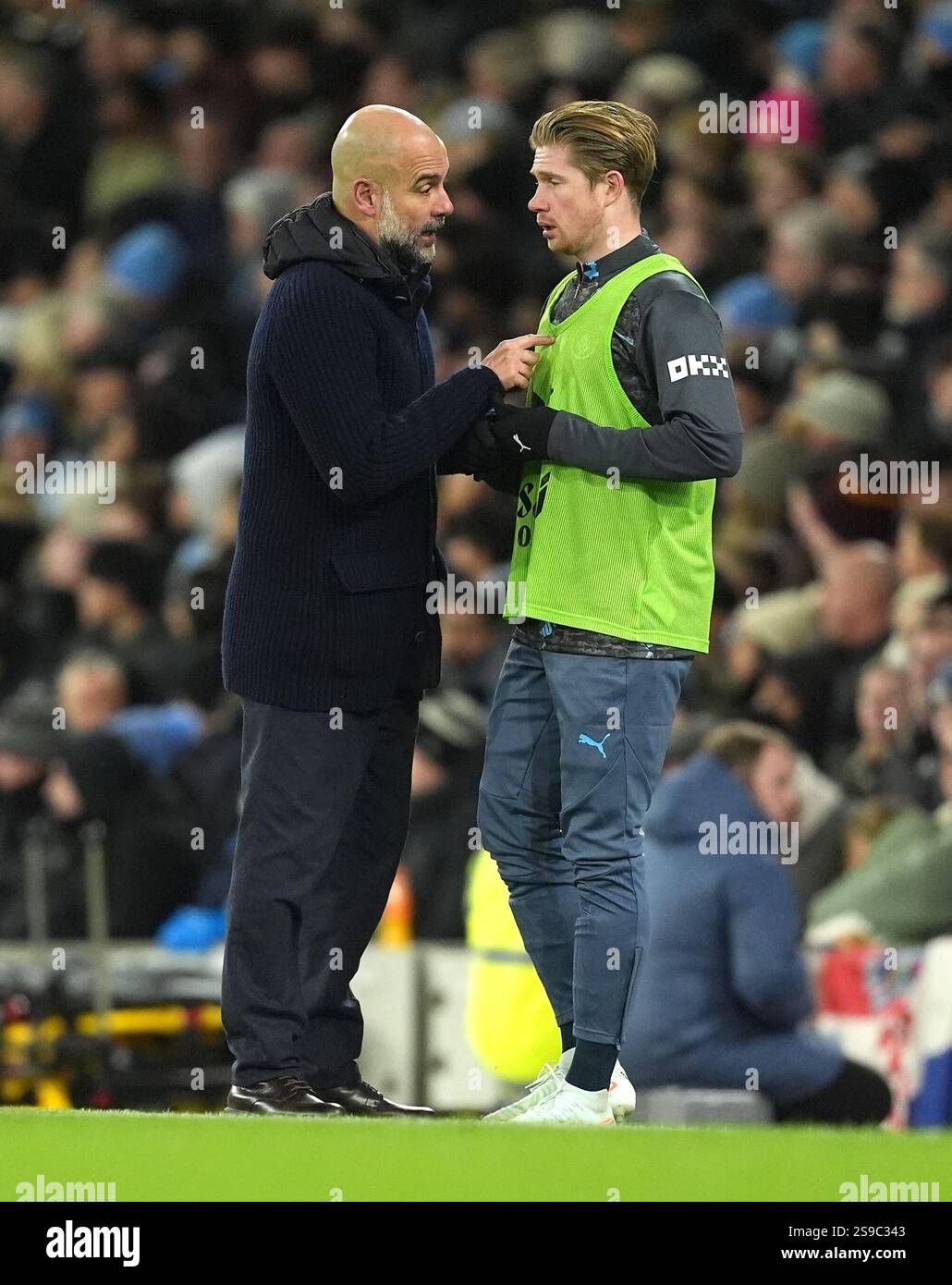 Manchester City manager Pep Guardiola (left) speaks with player Kevin ...