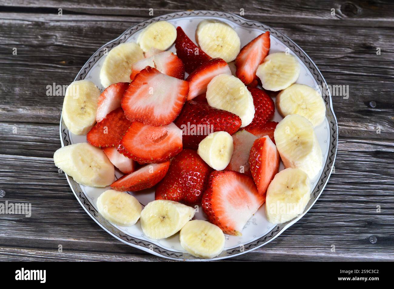 A plate of slices of strawberry and banana fruits, Strawberries are a ...