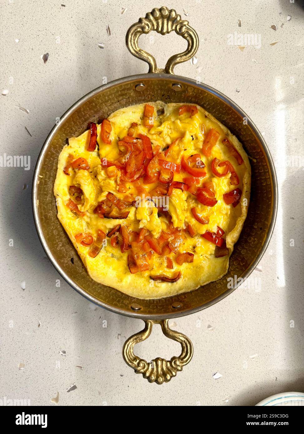 Scrambled eggs with red bell pepper in copper bowl for breakfast Stock ...