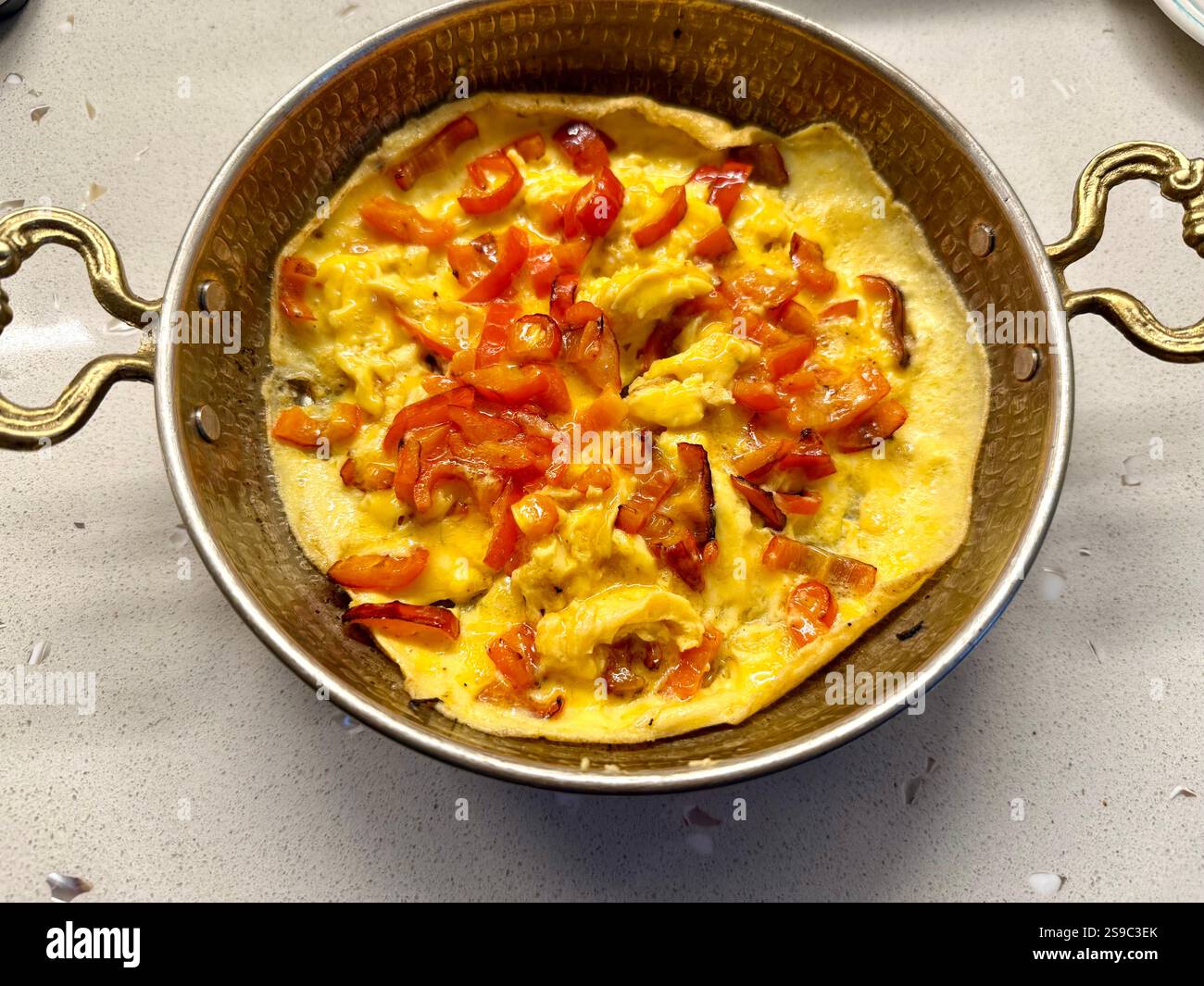 Scrambled eggs with red bell pepper in copper bowl for breakfast Stock ...