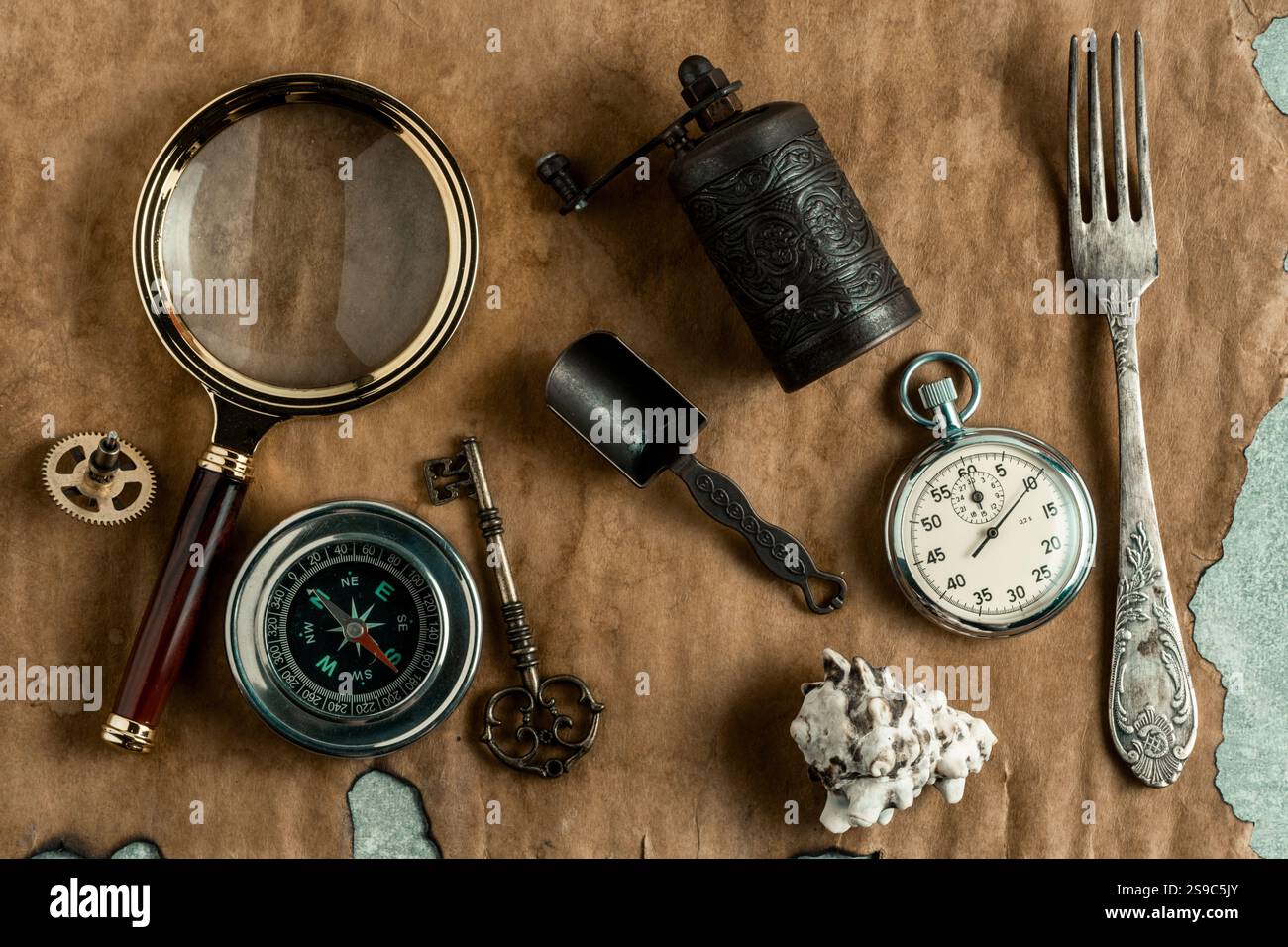 Vintage still life with compass, stopwatch, key, magnifying glass and ...