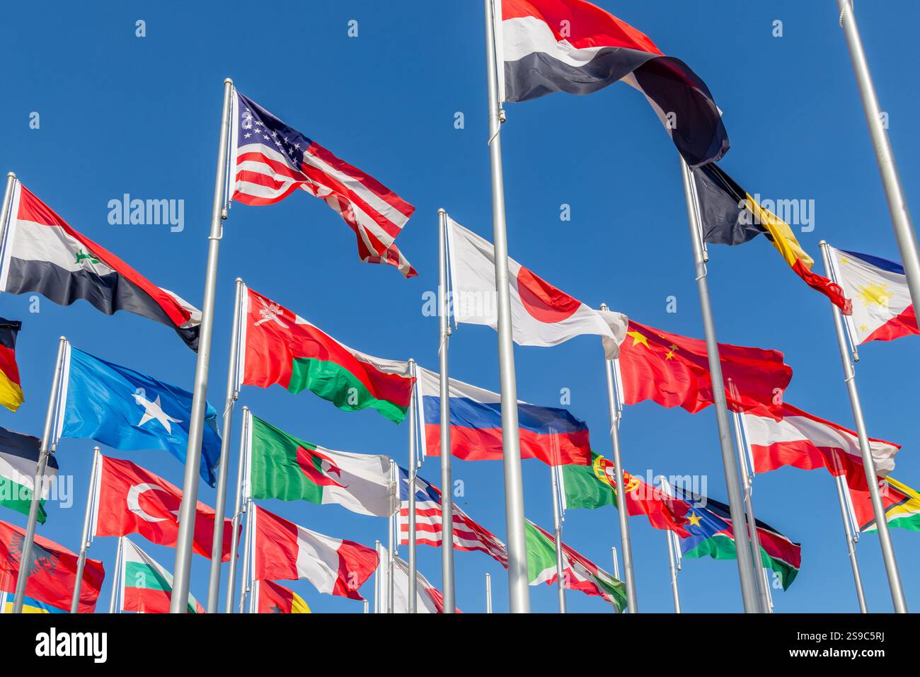 Many world's countries national flags waving together on the wind, with ...
