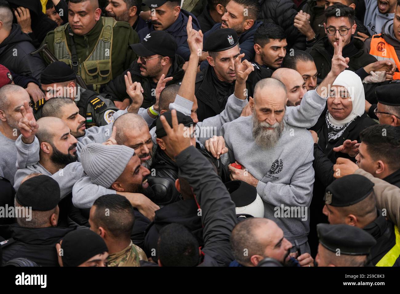 Palestinian Raed Al-Saadi, 57, right, and other prisoners are greeted ...