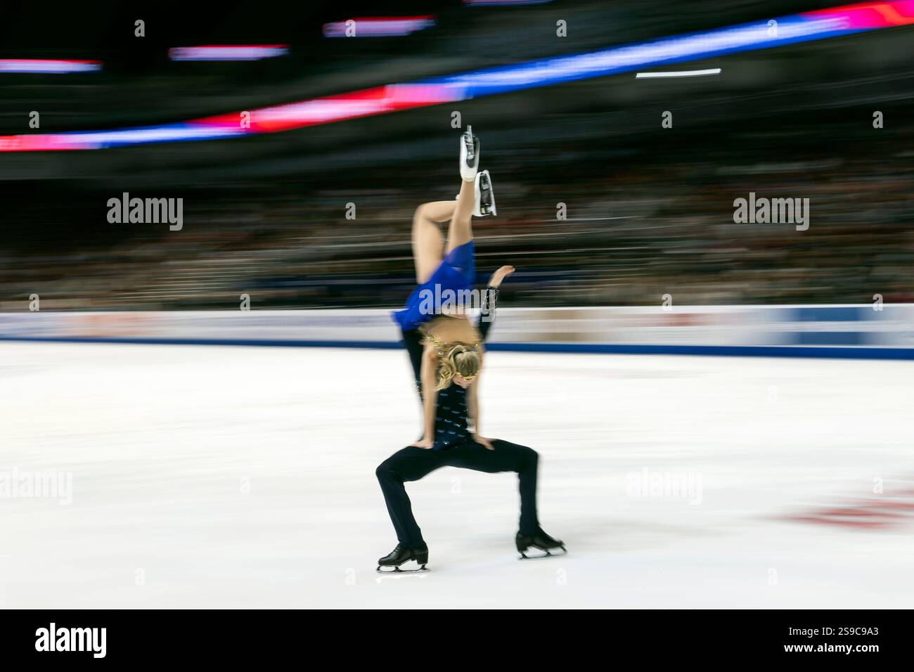 In this image taken with a slow shutter speed, Eva Pate, top, and Logan ...