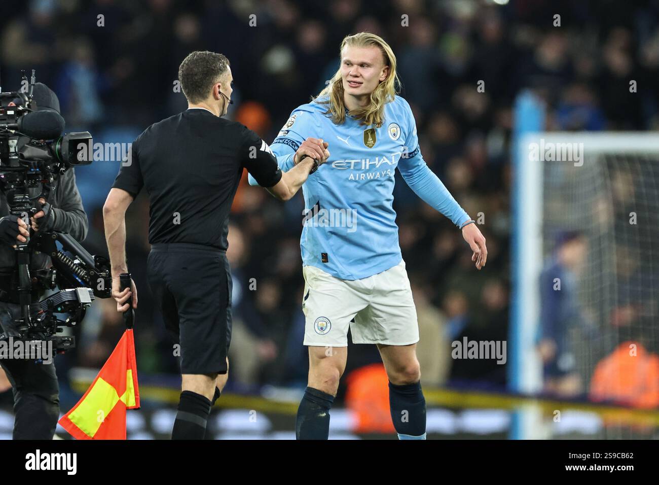 Referee John Brooks shakes hands with Erling Haaland of Manchester City ...