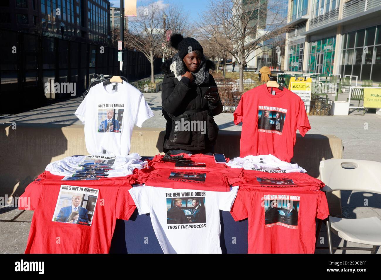 A woman sells Donald Trump t-shirt merchandise on Inauguration Day ...