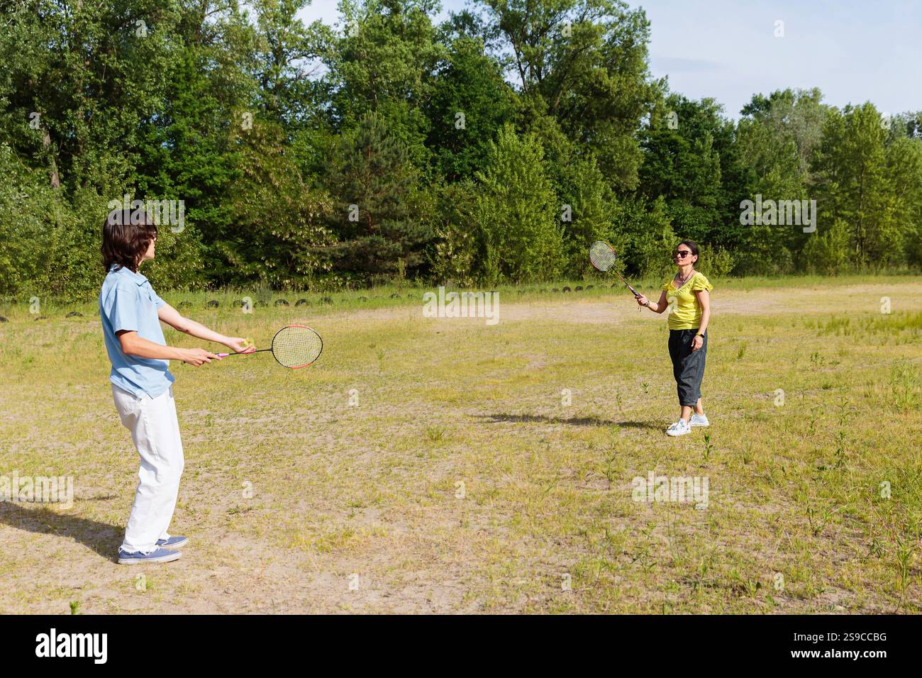 Teen Boy Serving Badminton Outdoors Stock Photo - Alamy