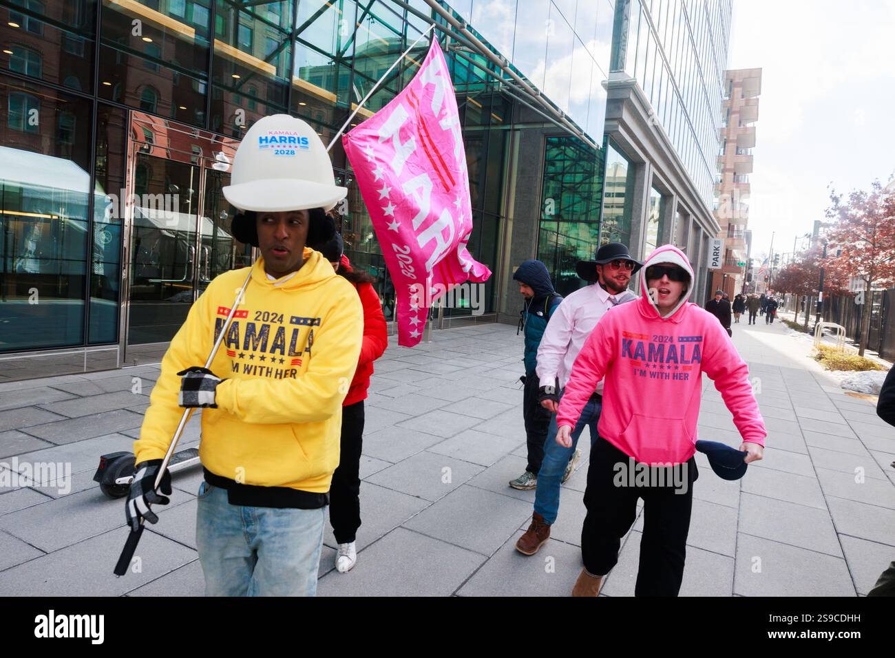 A group of men walk around dressed in Kamala Harris campaign gear ...