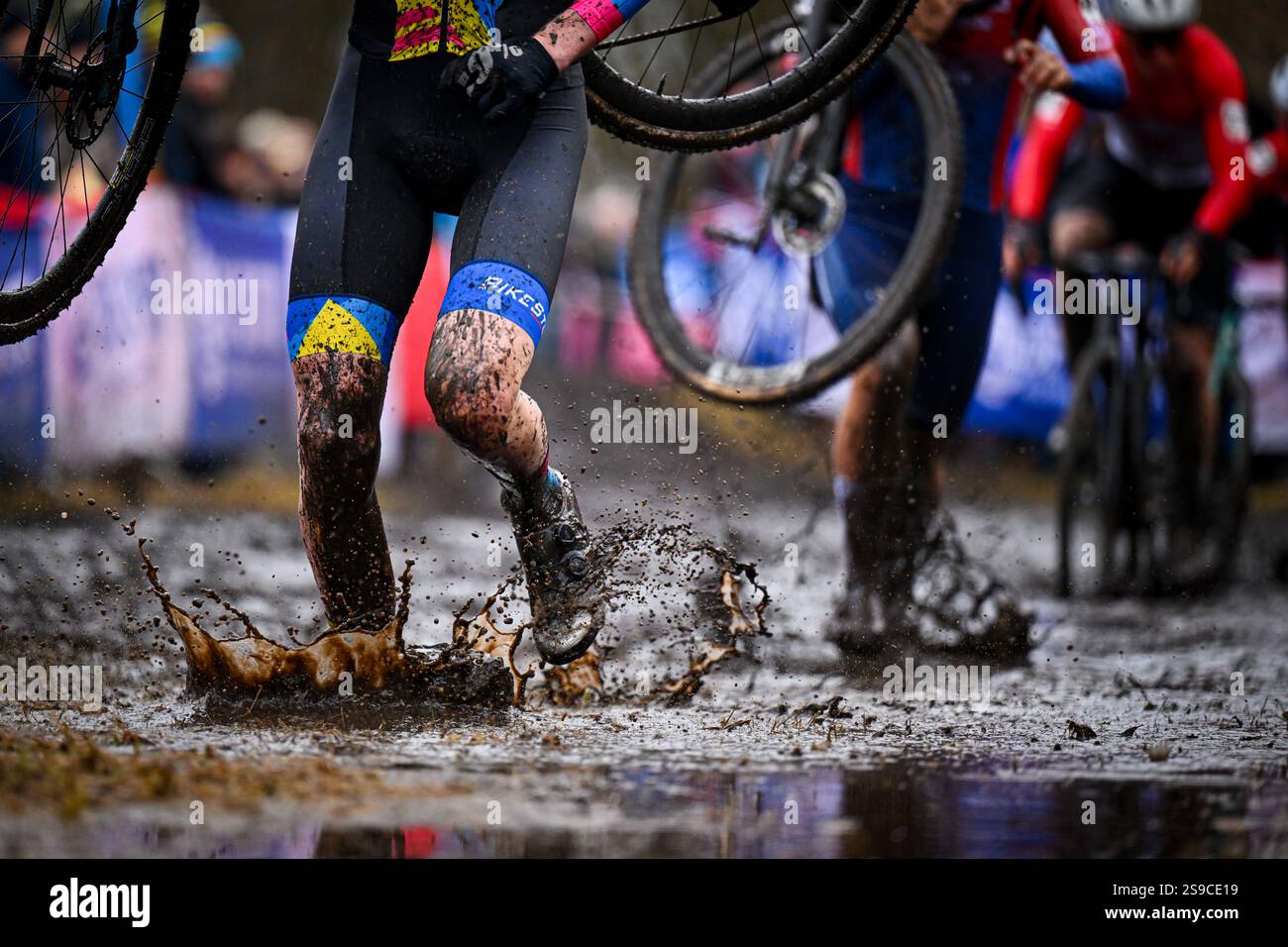 Riders pictured in the mud during the men's elite race at the World Cup ...