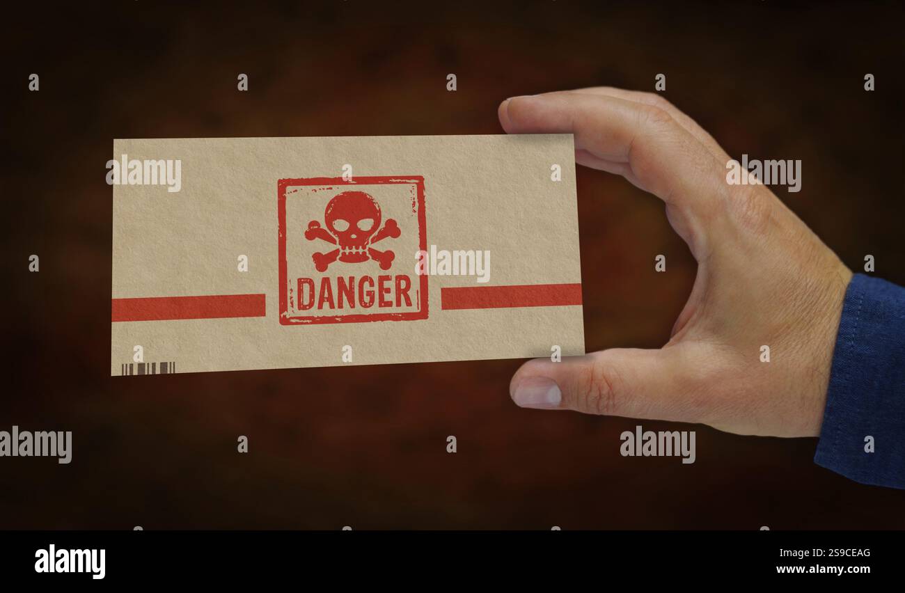 Danger with skull symbol box in hand. Toxic hazard sign cardboard pack ...