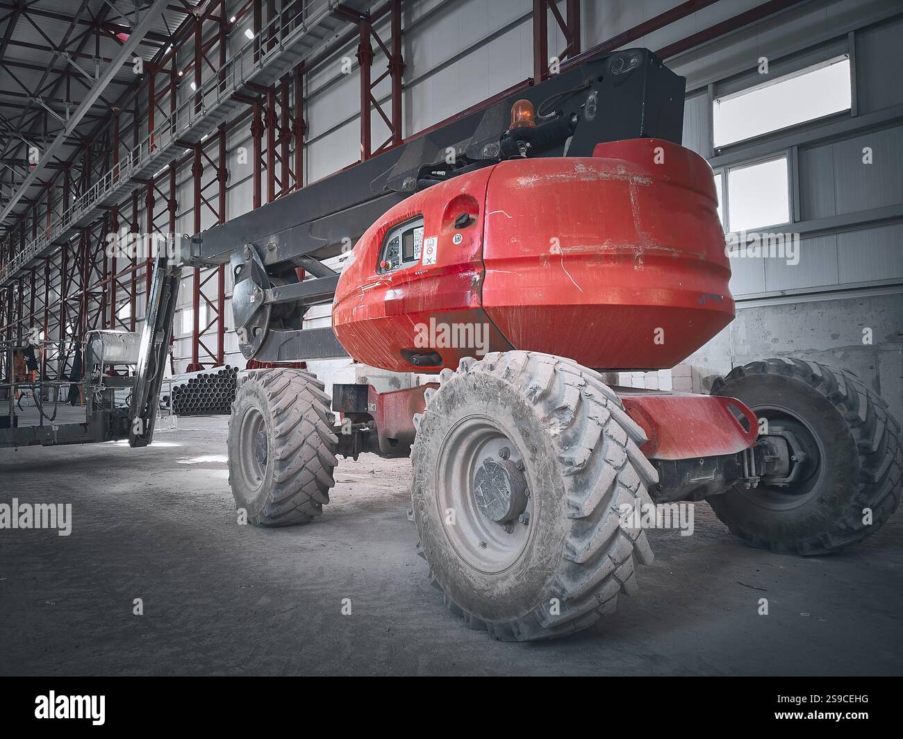 Boom lift picker inside industrial building Stock Photo - Alamy