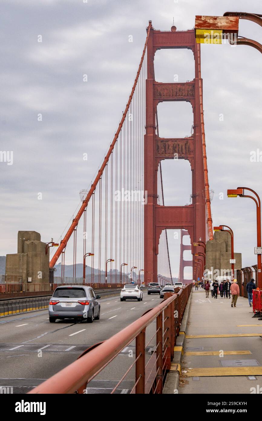 Pedestrians stroll along the pathway while vehicles navigate the ...
