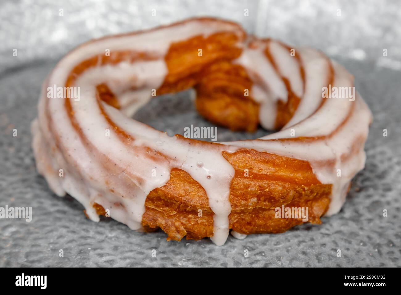 Elegant Iced Pastry Ring Captured on Metallic Gray Background in Close ...
