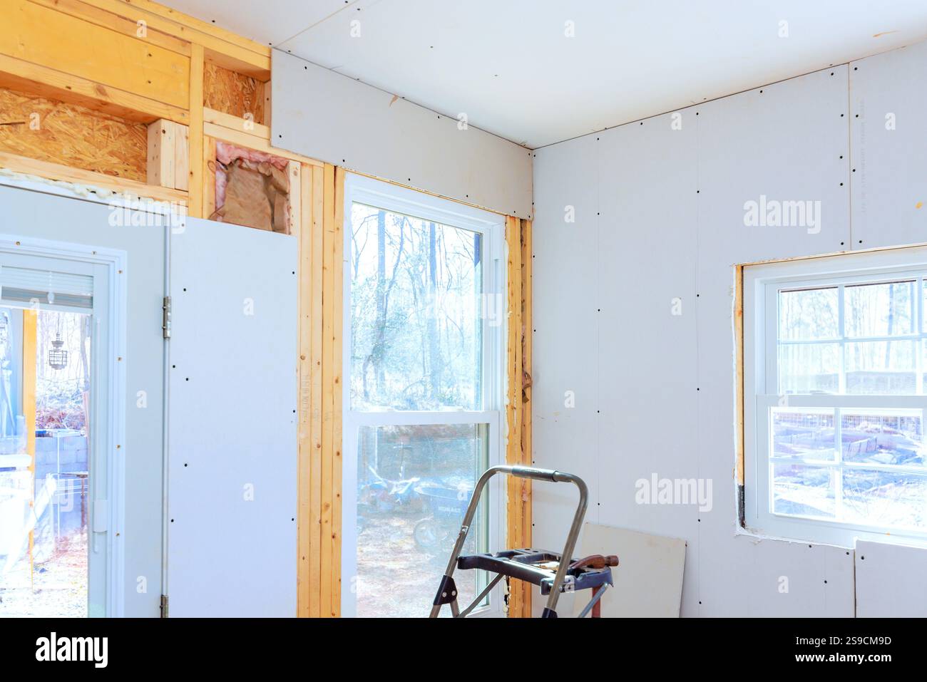 Installing gypsum drywall in space for improved energy efficiency ...