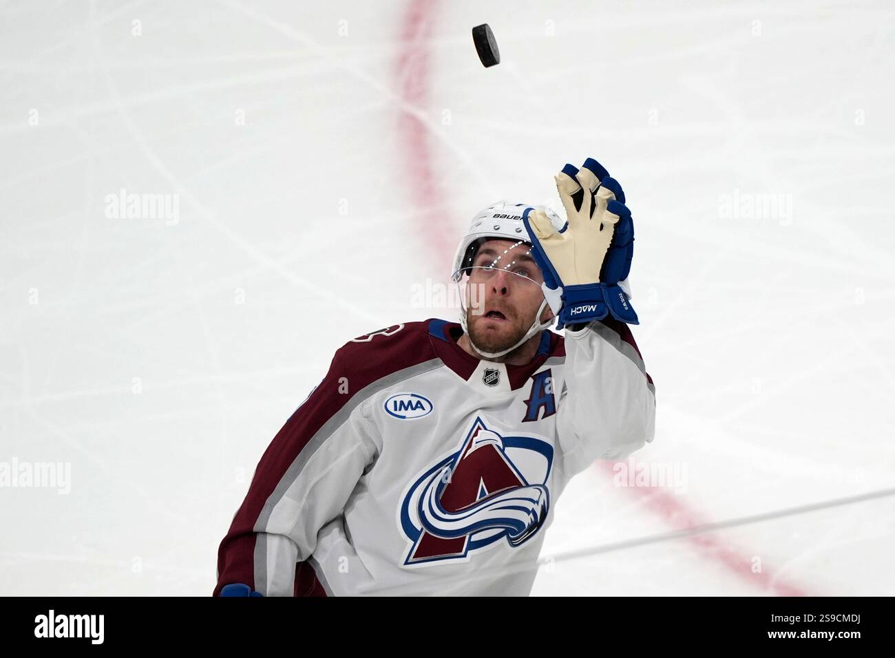 Colorado Avalanche defenseman Devon Toews (7) reaches for the puck ...