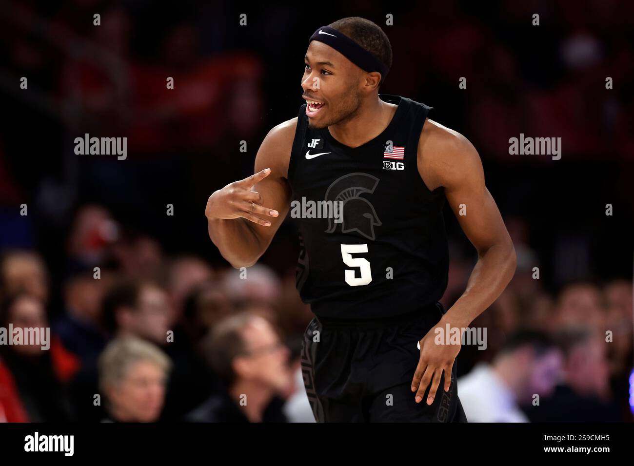 Michigan State guard Tre Holloman (5) reacts after making a three-point ...