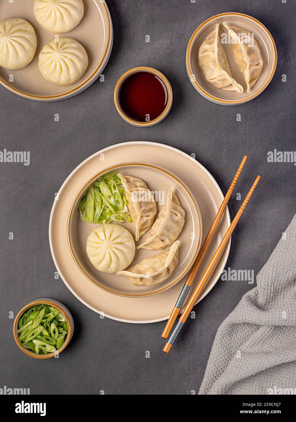Food photography of steamed duck bao buns and chicken gyoza, spring ...