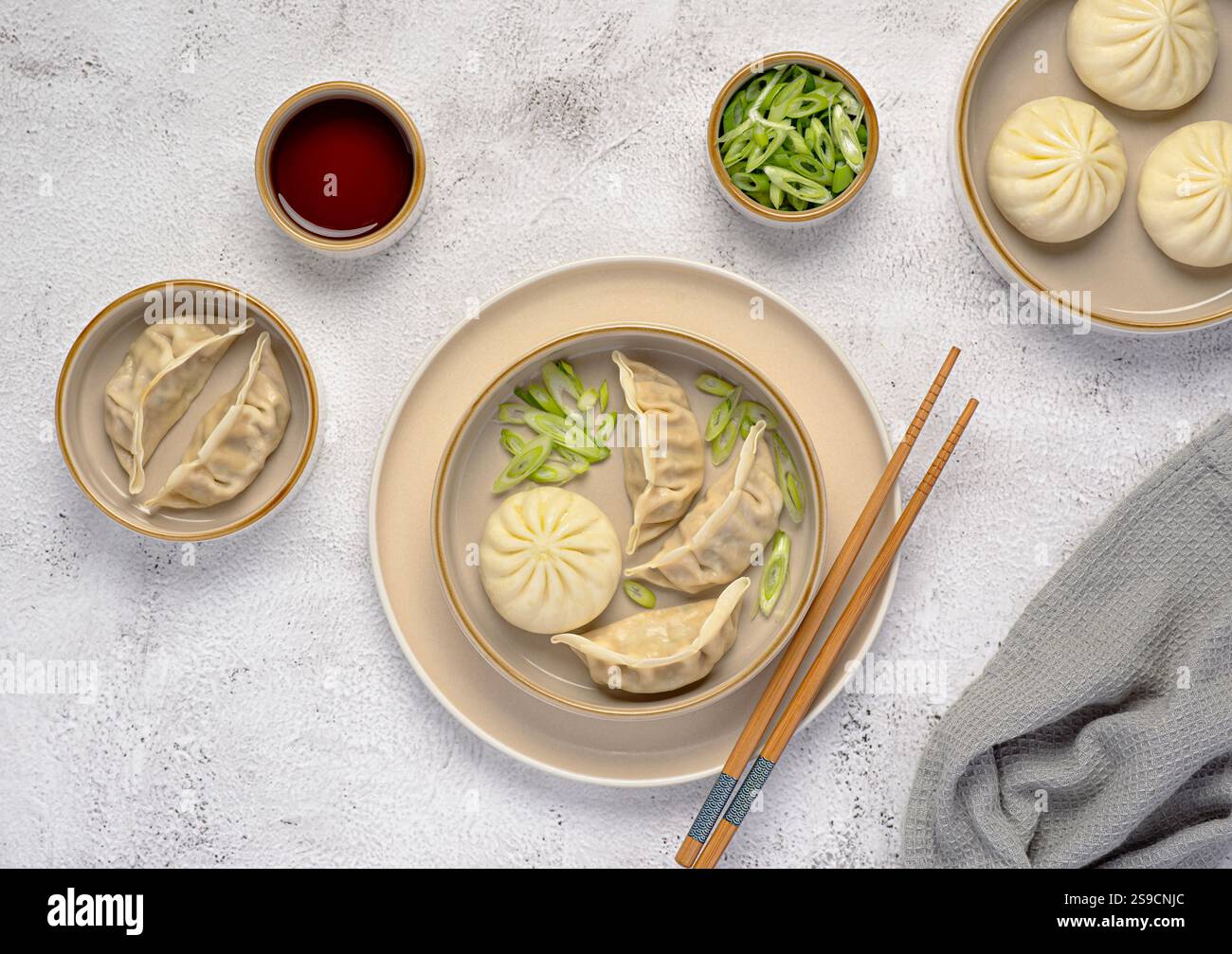 Food photography of steamed duck bao buns and chicken gyoza, spring ...