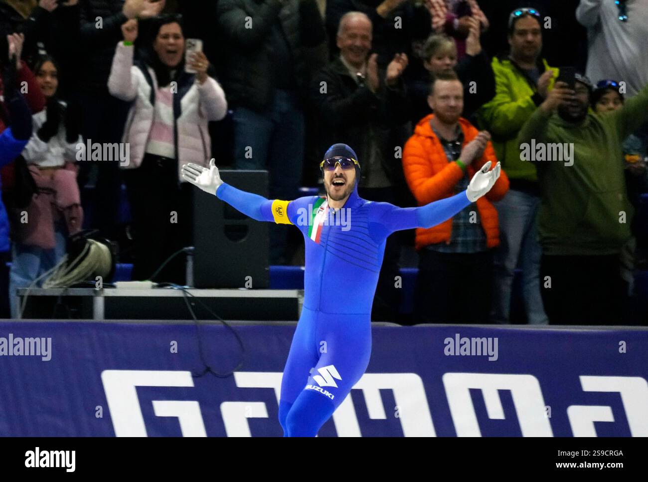 Italy's Davide Ghiotto celebrates finishing the men's 10,000-meter race ...