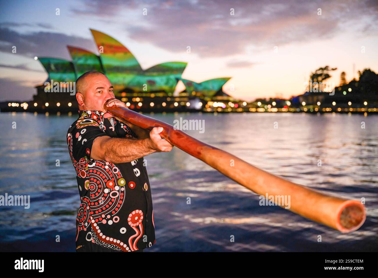 Man seen playing traditional instrument Didgeridoo in front of the ...