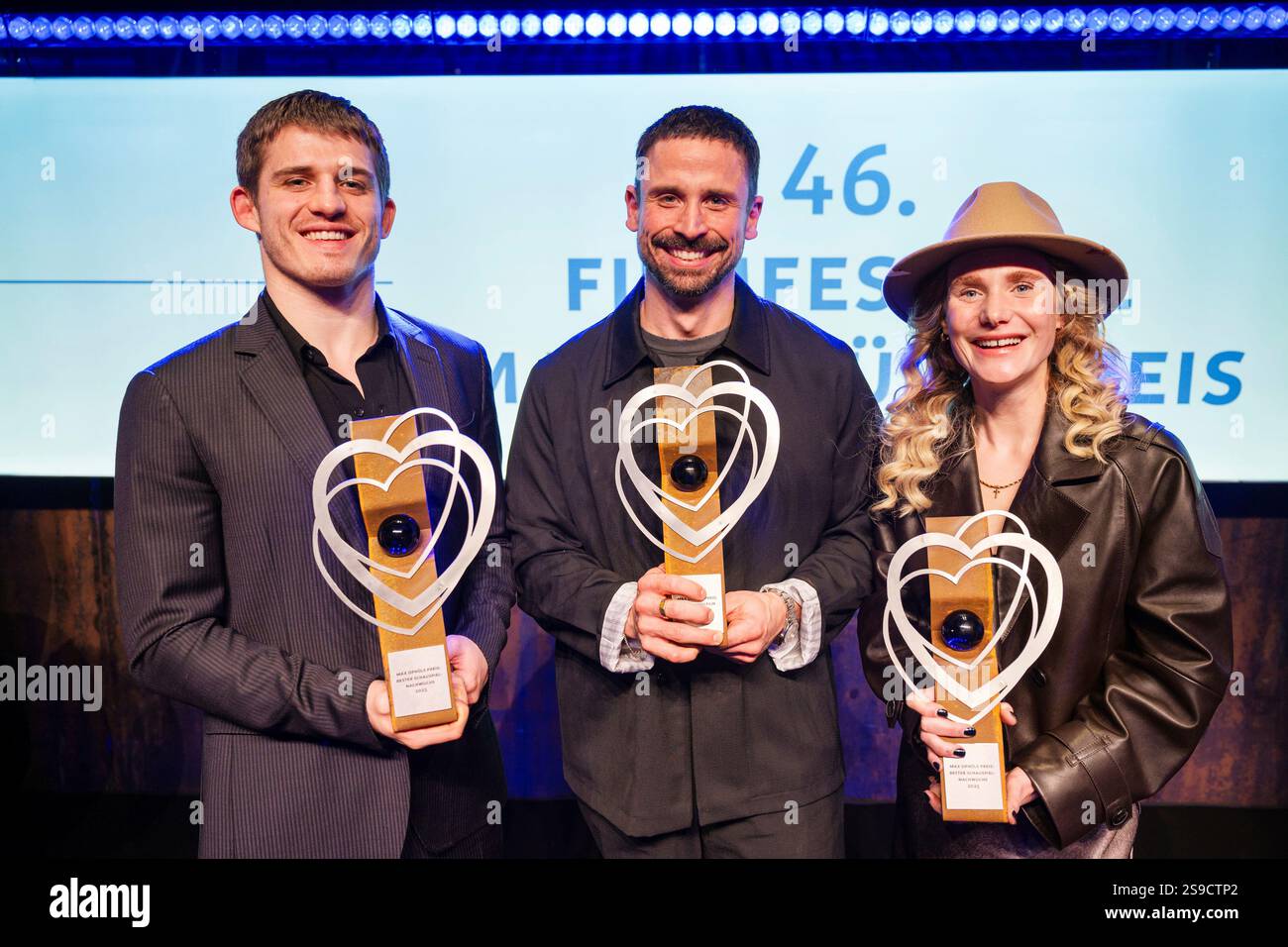 Director Lauro Cress, center, stands onstage after winning Best Feature ...