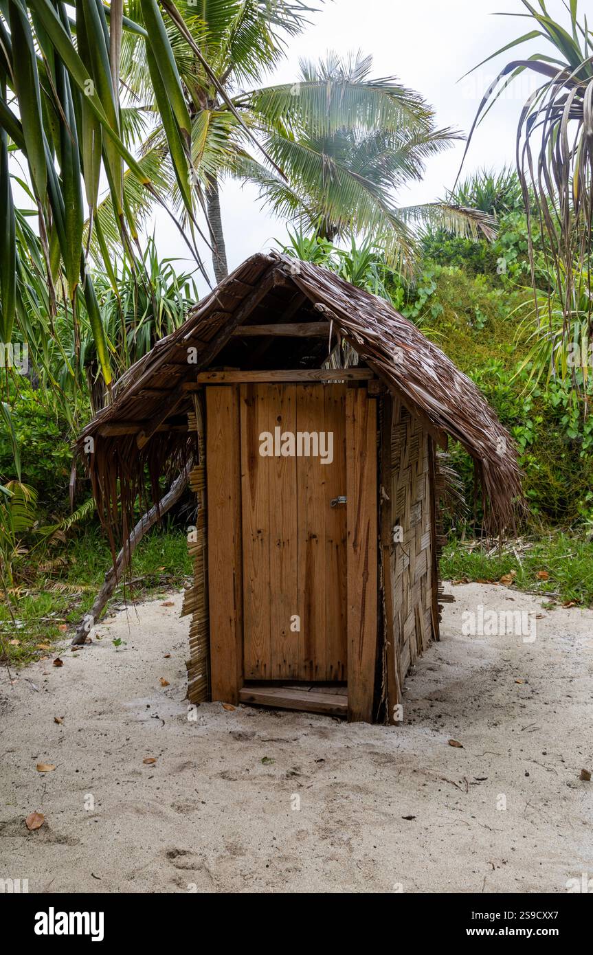 Rustic outdoor toilet with thatched roof in the lush, tropical ...
