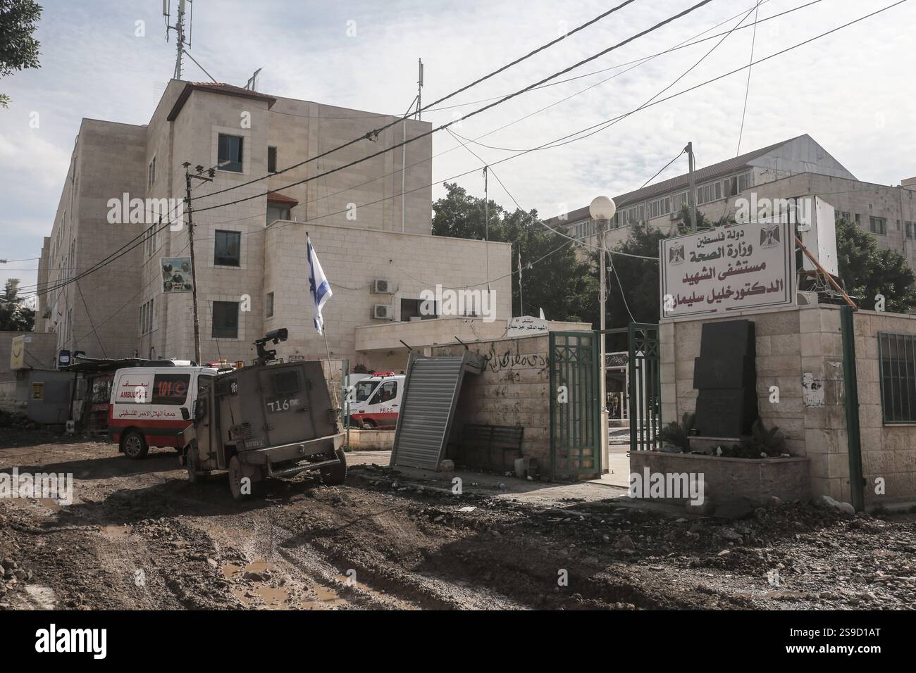 An Israeli military vehicle stands in front of the besieged Jenin ...