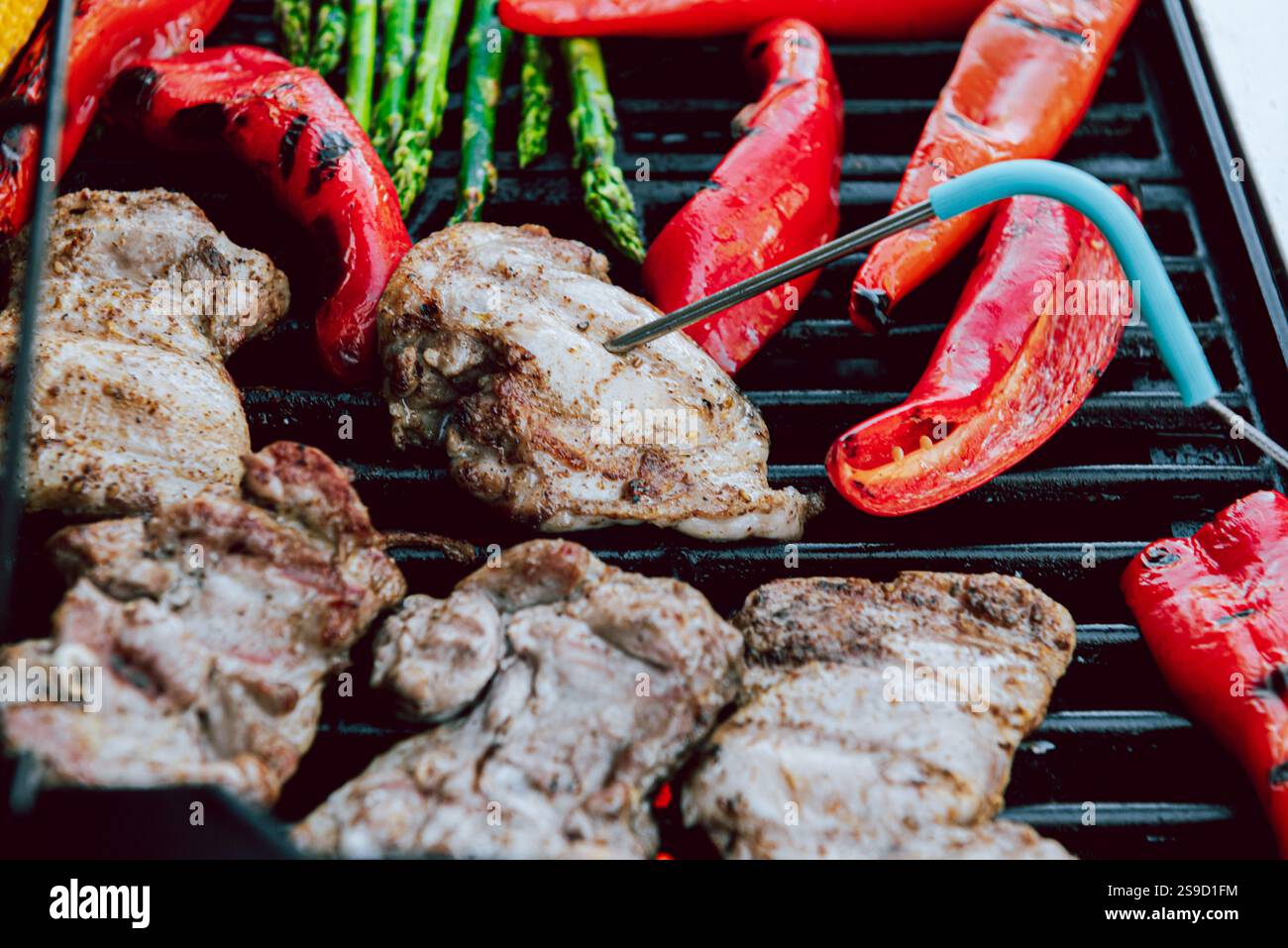 Cooking of meat and vegetables on a grill or on barbeque with ...