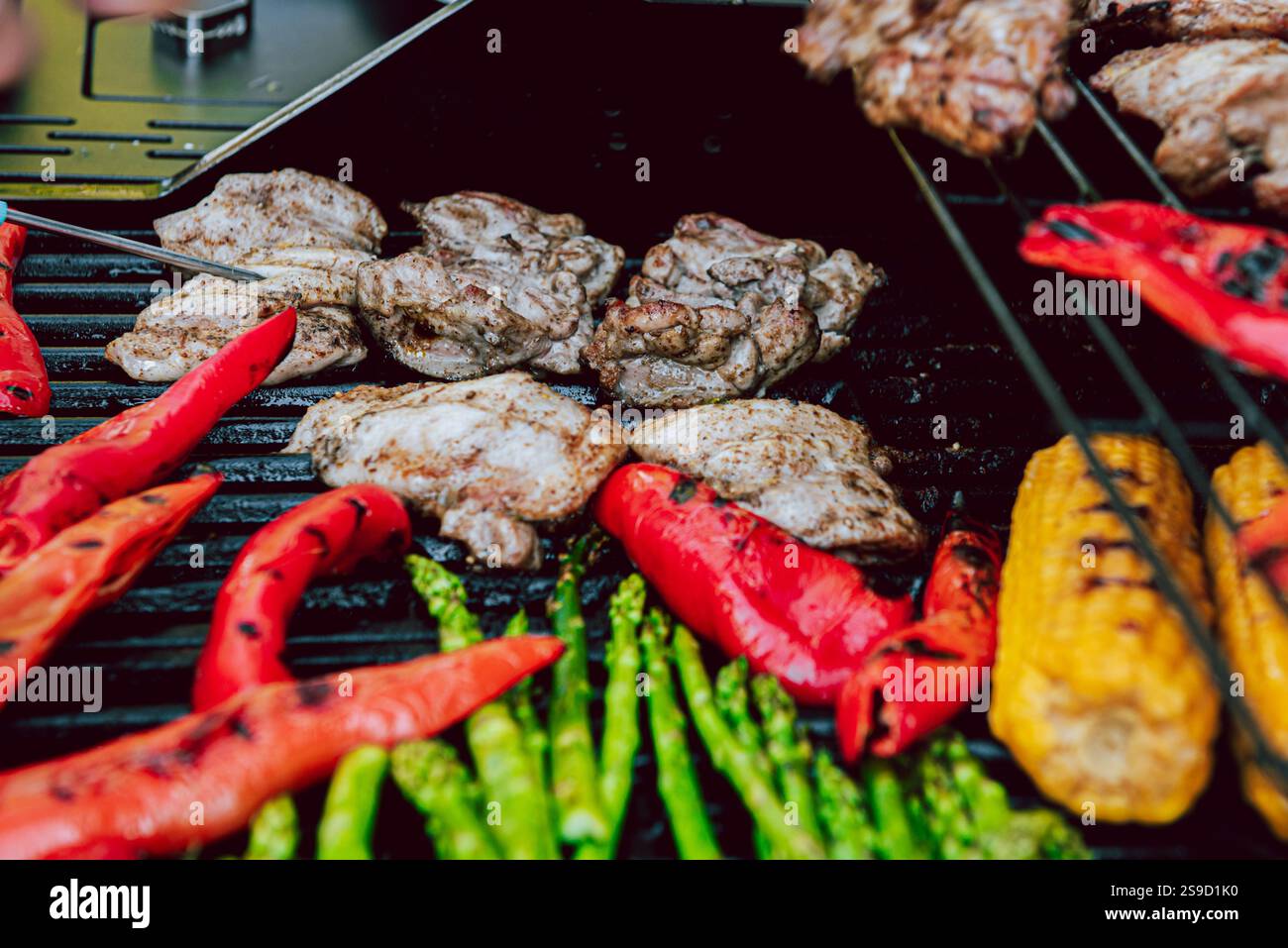 Cooking of meat and vegetables on a grill or on barbeque with ...