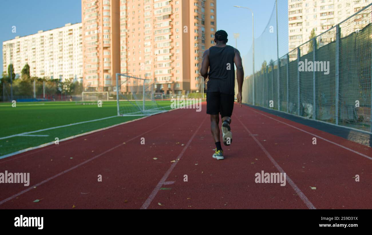 Low start position back view runner African American man guy sportsman ...