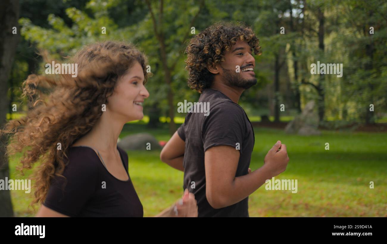 Fitness couple multiracial Caucasian woman and Arabian man running ...